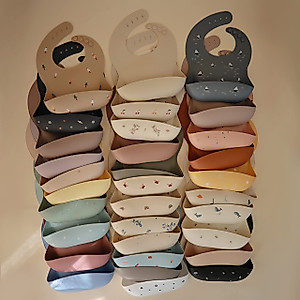 mushie Silicone Baby Bib | Adjustable Fit Waterproof Bibs (Rocket Ship)