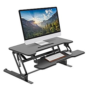Mount-It! Height Adjustable Standing Desk Converter, 38” Wide, Stand Up Desk Riser for 2 Monitors, Manual Gas Spring Desktop Raises to 16.9", Fits Two Monitor Screens with Keyboard Mouse Tray in Black