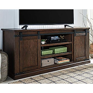 Signature Design by Ashley Budmore Rustic TV Stand Fits TVs up to 68", 2 Sliding Barn Doors and 6 Storage Shelves, Dark Brown