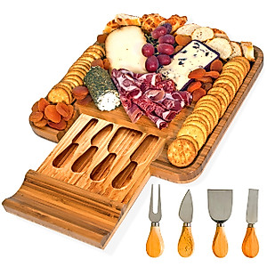 Roots To Table Bamboo Cheese and Charcuterie Board Set. This Cheese Board Set is a Perfect Cheese Platter and Charcuterie Board Gift Set Idea. Slide-Out Drawer Contains Stainless Steel Knife Set.