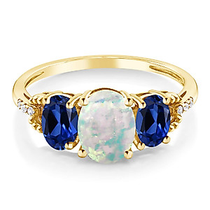 Gem Stone King 10K Yellow Gold White Simulated Opal and Blue Created Sapphire Engagement Ring For Women (2.24 Cttw, Oval Cabochon Cut) (Size 8)
