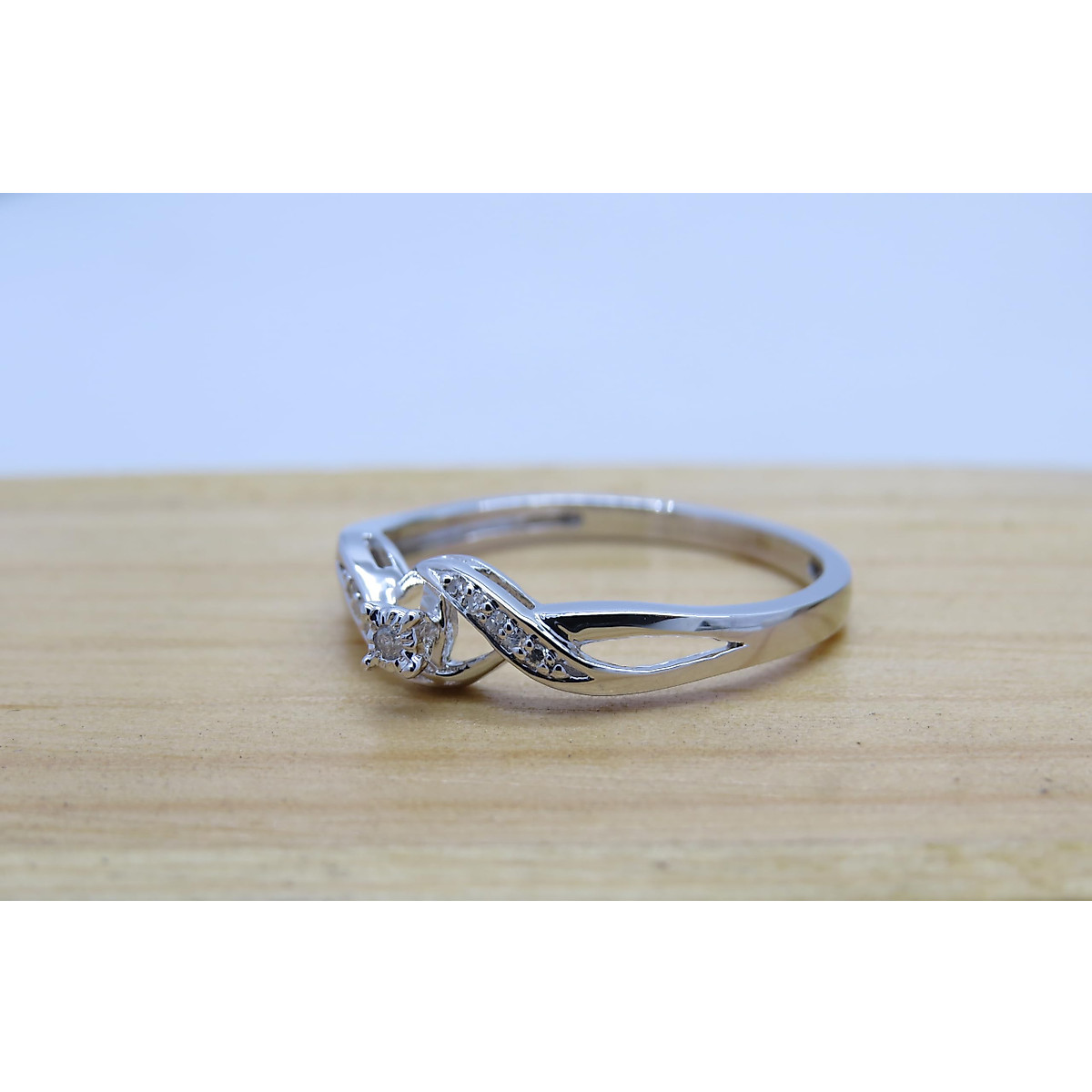 Dazzlingrock Collection Round White Diamond Crossover Swirl Promise Engagement Ring for Women (0.06 ctw, Color I-J, Clarity I2-I3) in 925 Sterling Silver Size 7