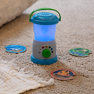 Melissa & Doug Let’s Explore Light & Sound Camping Lantern Play Set, lantern, 3 double-sided cards to set the scene (cards store in bottom of lantern), collectible medallion