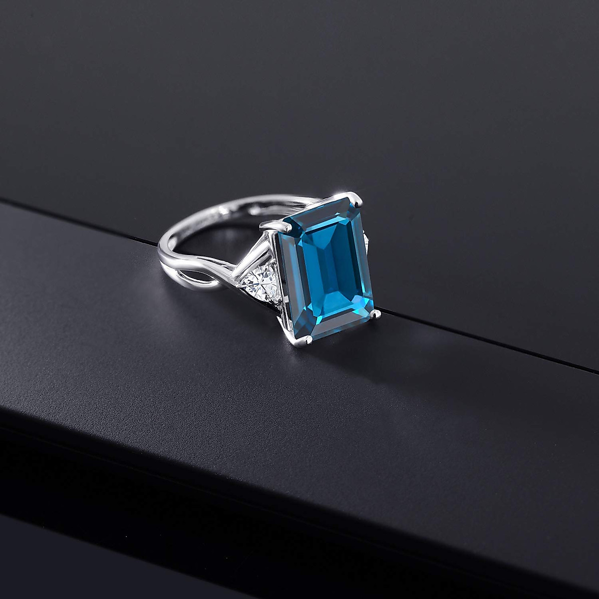 Gem Stone King 10K White Gold London Blue Topaz and White Moissanite 3 Stone Engagement Ring For Women (9.96 Cttw, Emerald Cut 14X10MM, Trillion 4MM, Available in Size 5,6,7,8,9)