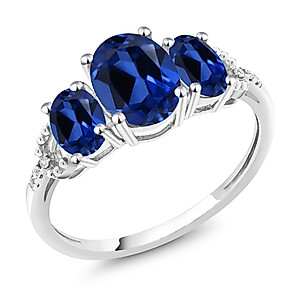 Gem Stone King 10K White Gold Oval Blue Created Sapphire and Diamond Accent 3-Stone Women Engagement Ring (2.65 Cttw) (Size 5)
