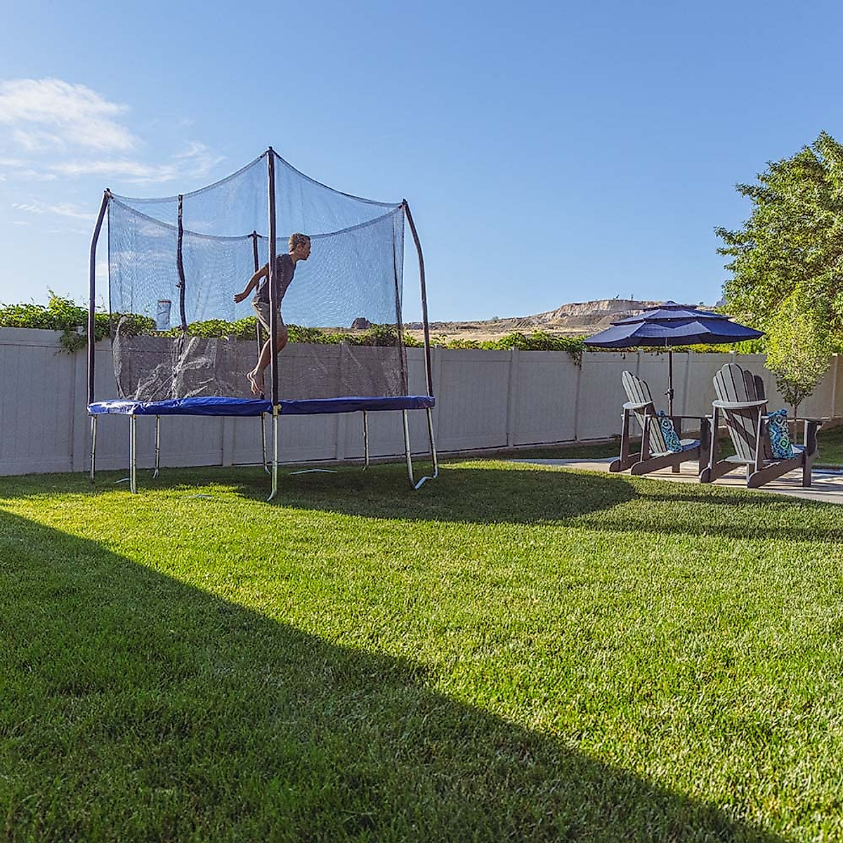SKYWALKER TRAMPOLINES 10 FT Round, Outdoor Trampoline for Kids with Enclosure Net Basketball Hoop, Spring Pad Cover, ASTM Approval, 700 LBS Weight Capacity