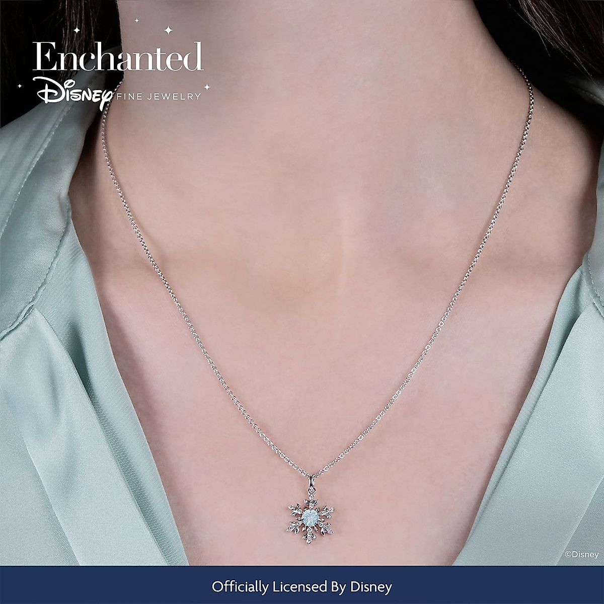 Jewelili Enchanted Disney Fine Jewelry Sterling Silver with 1/8 Cttw Diamonds and Blue Topaz Elsa Snowflake Pendant