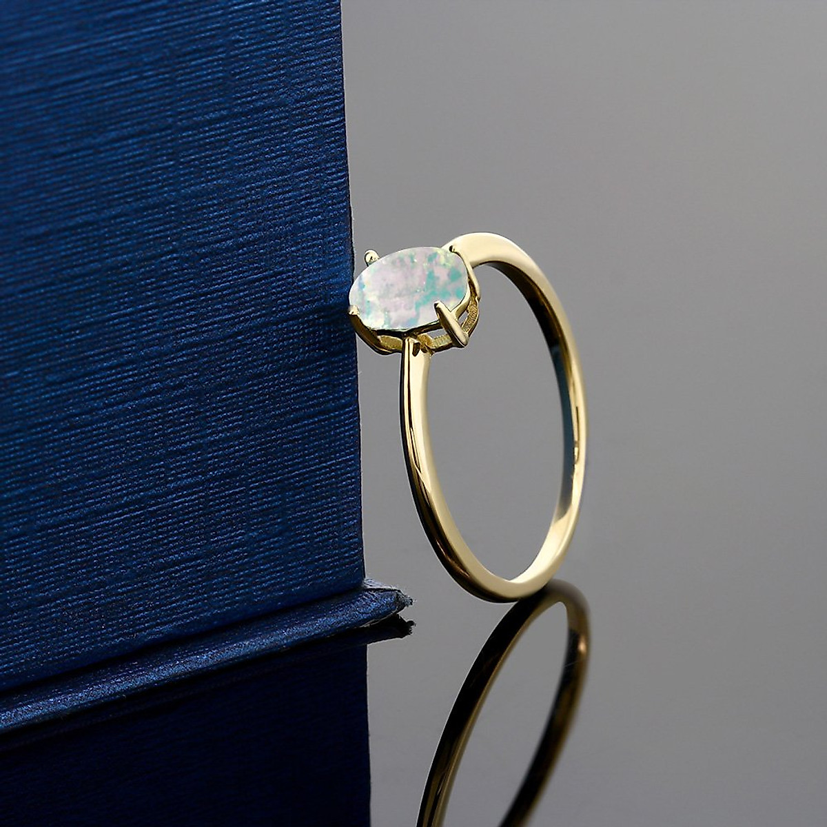 Gem Stone King 10K Yellow Gold White Simulated Opal Solitaire Engagement Ring For Women | 0.63 Cttw | Oval Cabochon 7X5MM | Gemstone October Birthstone | Available in Size 5-10