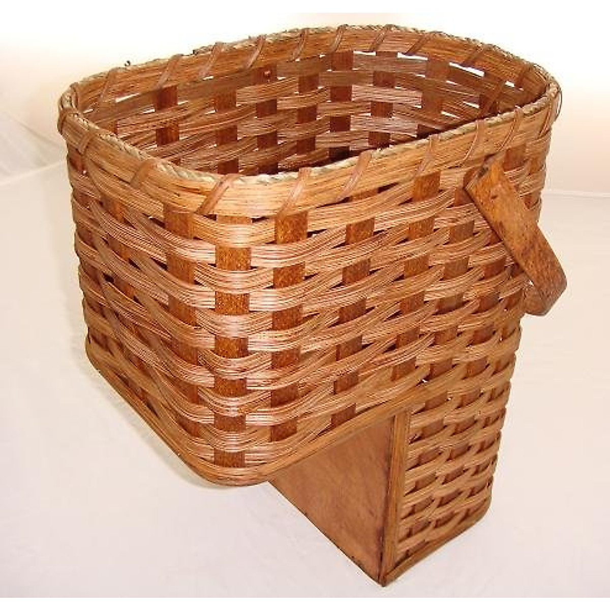 Large 9" stair step basket. Beautifully rests on your stairsteps. Swivel handle, all natural material and made by Old Order Amish. The up splints that are used are on these baskets are oak. Perfect for storing books and magazines. Colors may vary.