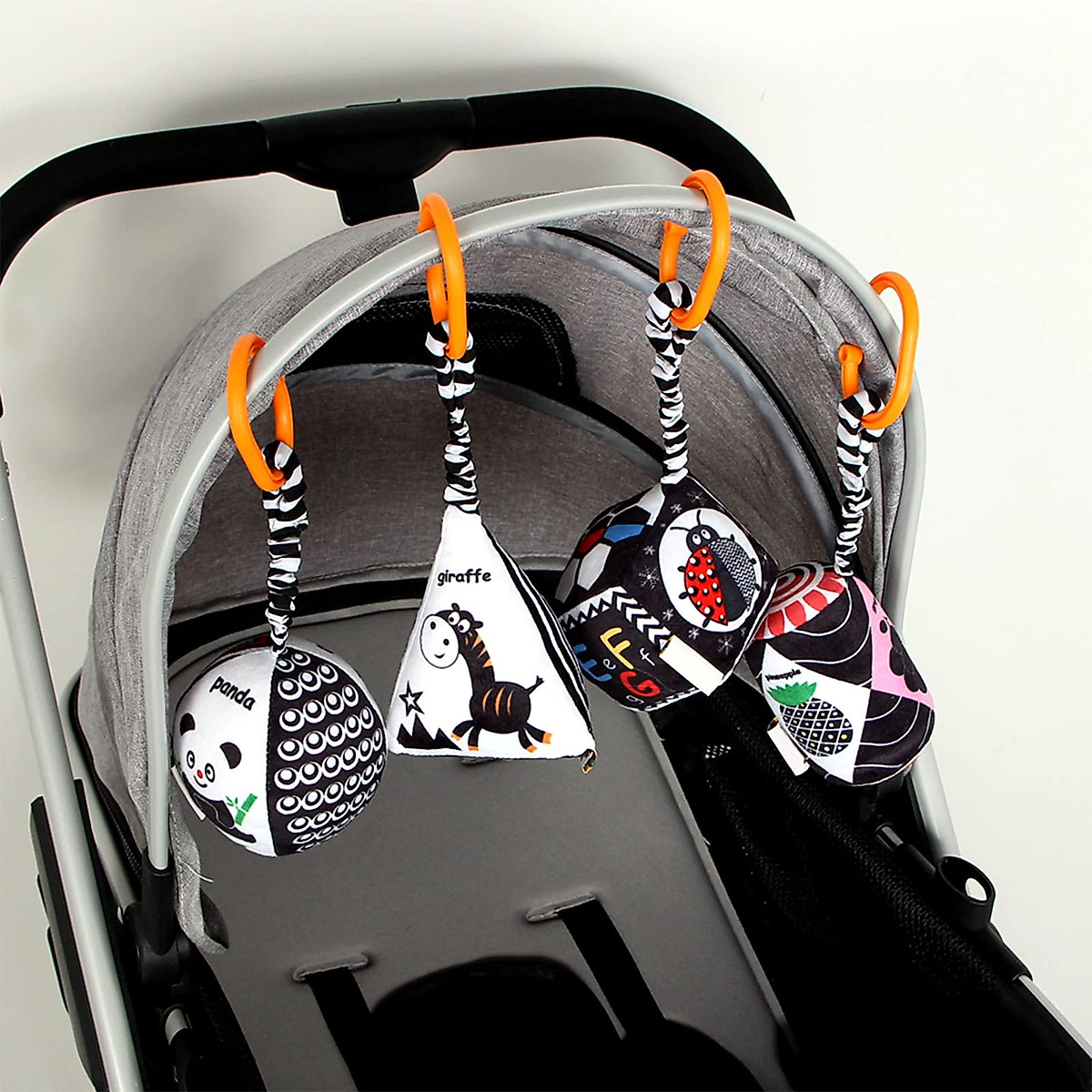 KAKIBLIN Baby Hanging Rattle Toys, 4 Pack Black and White Car Seat Baby Toys Soft Squeaky Stroller Toy for Baby Montessori Sensory Toys 0-12 Months for Newborn Infant, White and Black