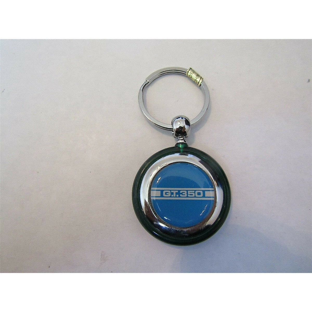 1965 1966 1967 1968 1969 1970 SHELBY GT-350 WHITE STRIPE ON BLUE ROUND PLASTIC KEYCHAIN - GREEN