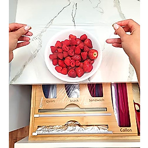 Redesigned and OVERSIZED ZipLock Bag storage organizer with plastic wrap and aluminum foil dispenser with cutter. 4 slots - Quart, Sandwich, Freezer and Gallon size.