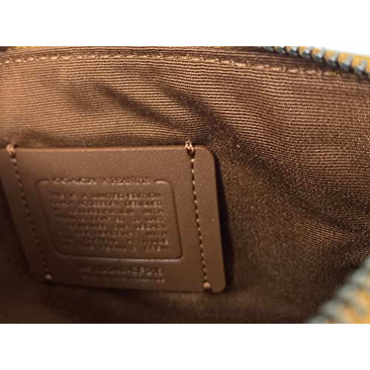 COACH X Peanuts Corner Zip Wristlet With Snoopy Present Motif