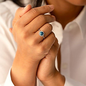 PEORA London Blue Topaz Ring for Women 14K White Gold with White Topaz, Genuine Gemstone Birthstone, 1.25 Carats Round Shape 6.5mm, Halo Design, Size 5