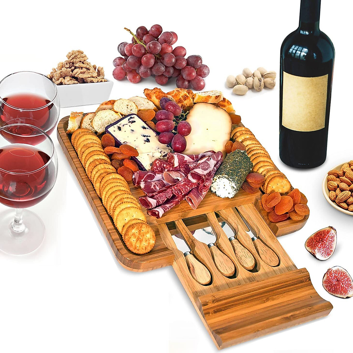 Roots To Table Bamboo Cheese and Charcuterie Board Set. This Cheese Board Set is a Perfect Cheese Platter and Charcuterie Board Gift Set Idea. Slide-Out Drawer Contains Stainless Steel Knife Set.