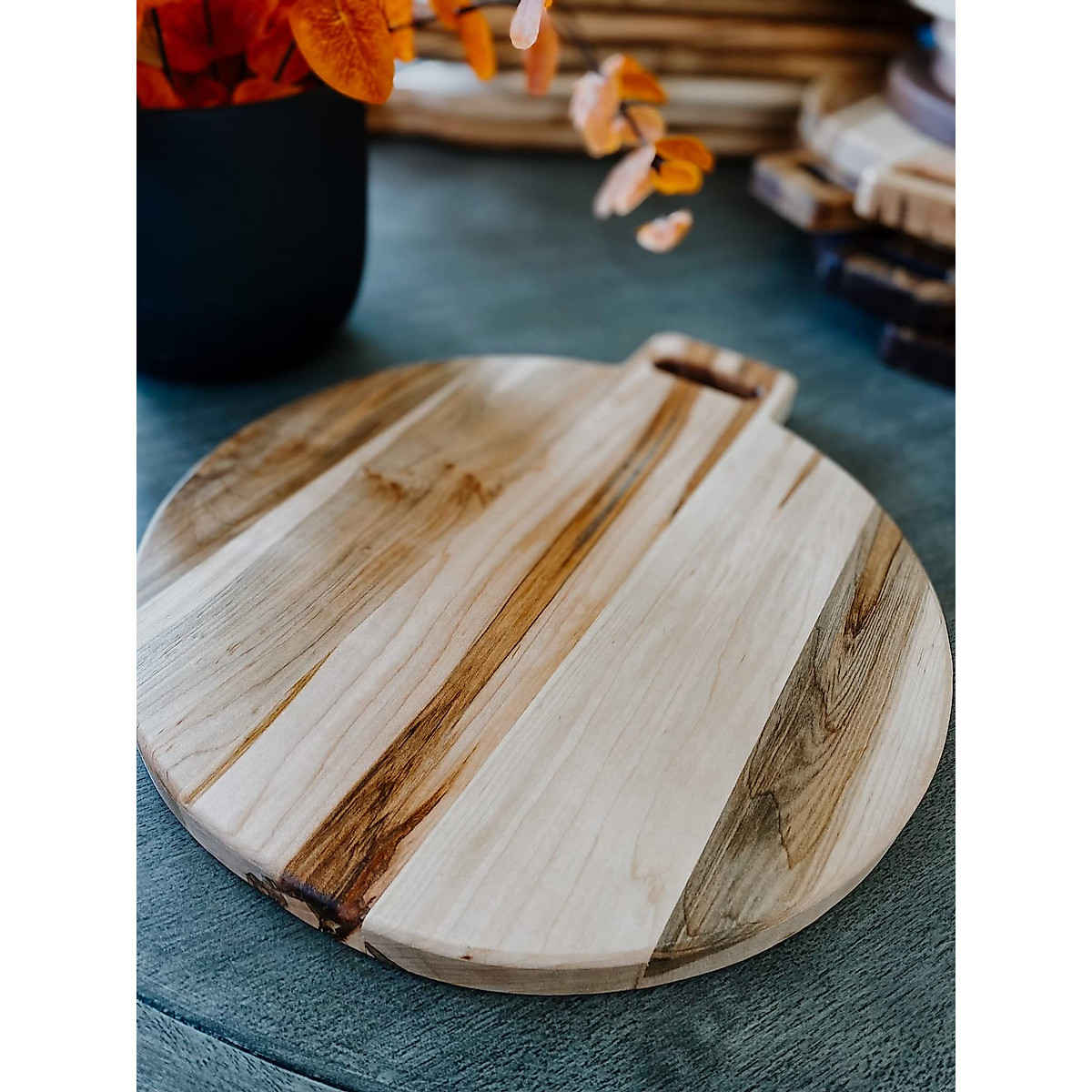 Round charcuterie serving board with handle, handmade in the USA with Maple hardwood.