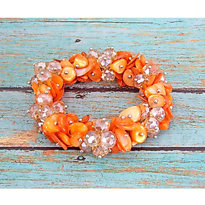 Calisa Designs Woman's orange shell and glass beaded stretch bracelet with silver beads, Designed with clusters of orange shell and orange facet cut glass beads.