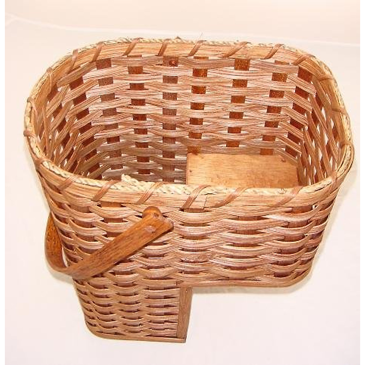 Large 9" stair step basket. Beautifully rests on your stairsteps. Swivel handle, all natural material and made by Old Order Amish. The up splints that are used are on these baskets are oak. Perfect for storing books and magazines. Colors may vary.