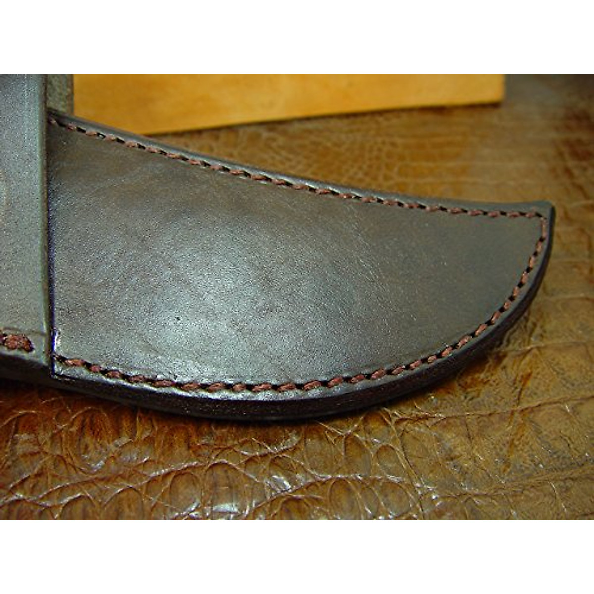 Custom-made Cross Draw Knife Sheath for the Buck Kalinga 401 Knife. The Sheath Is Made Out of 10 Ounce Water Buffalo Hide Leather. The 10 oz. Leather is Dyed Dark Brown. The Sheath Also Has a Strap for Extra Security of Your Knife From Falling Out. The Sh