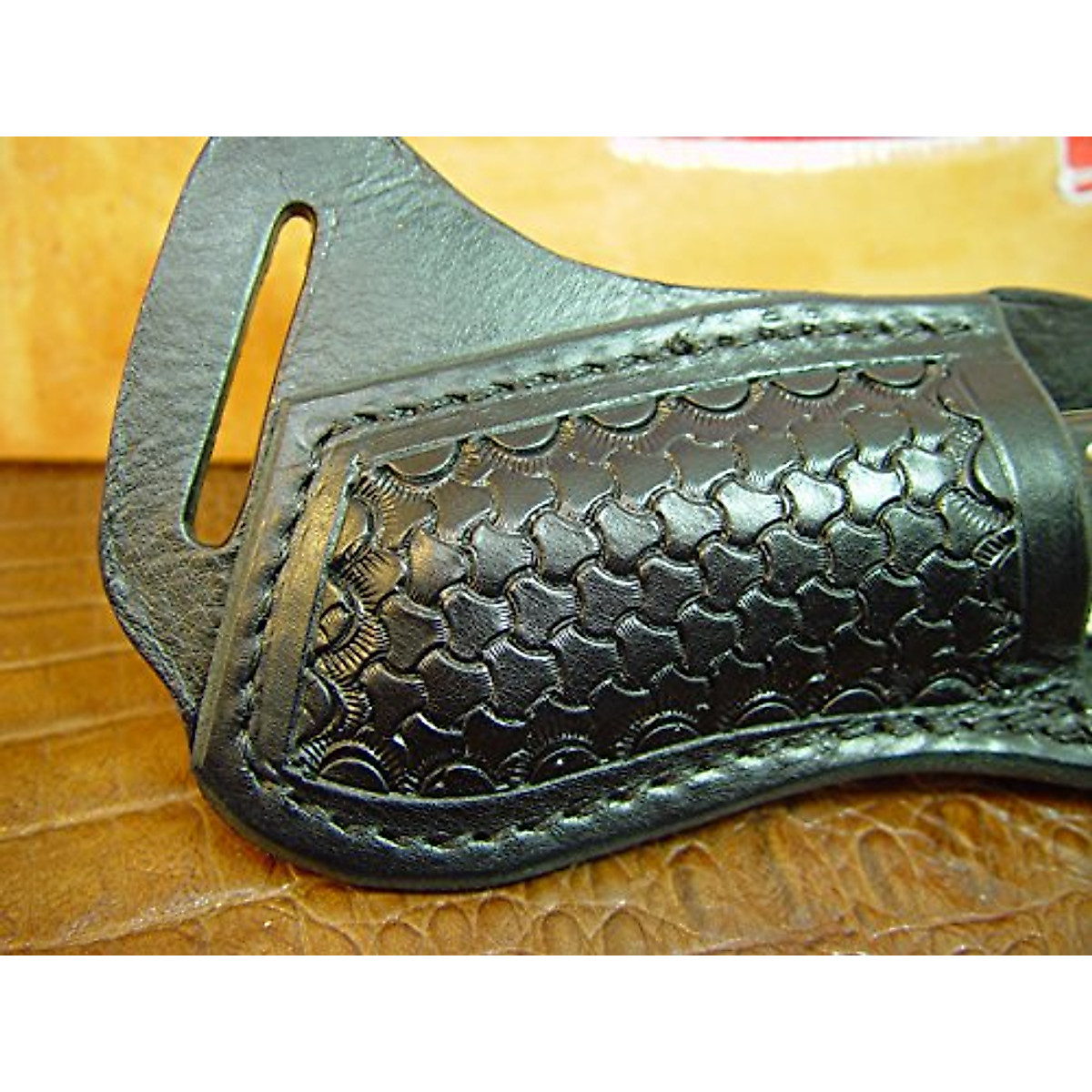 Buck Custom Left Hand Cross Draw Knife Sheath for a 110 Knife. The Sheath is Made Out of Buffalo Hide Leather Hand Tooled with a Basket Weave Pattern.