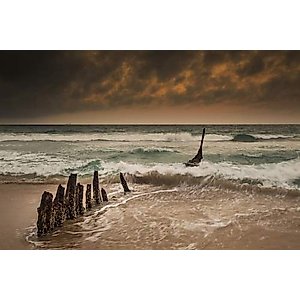 Posterazzi Wooden posts on a beach with a boat being tossed in the water and waves crashing into the sand under a cloudy sky Queensland Australia Poster Print, (38 x 24)
