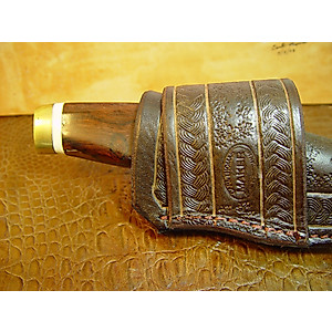 New Buck Vanguard Cross Draw Knife Sheath. Made of 10 Oz Water Buffalo Leather and Has a Rope Pattern Tooling with Random Patterning in the Center of the Sheath. Sheath ONLY!
