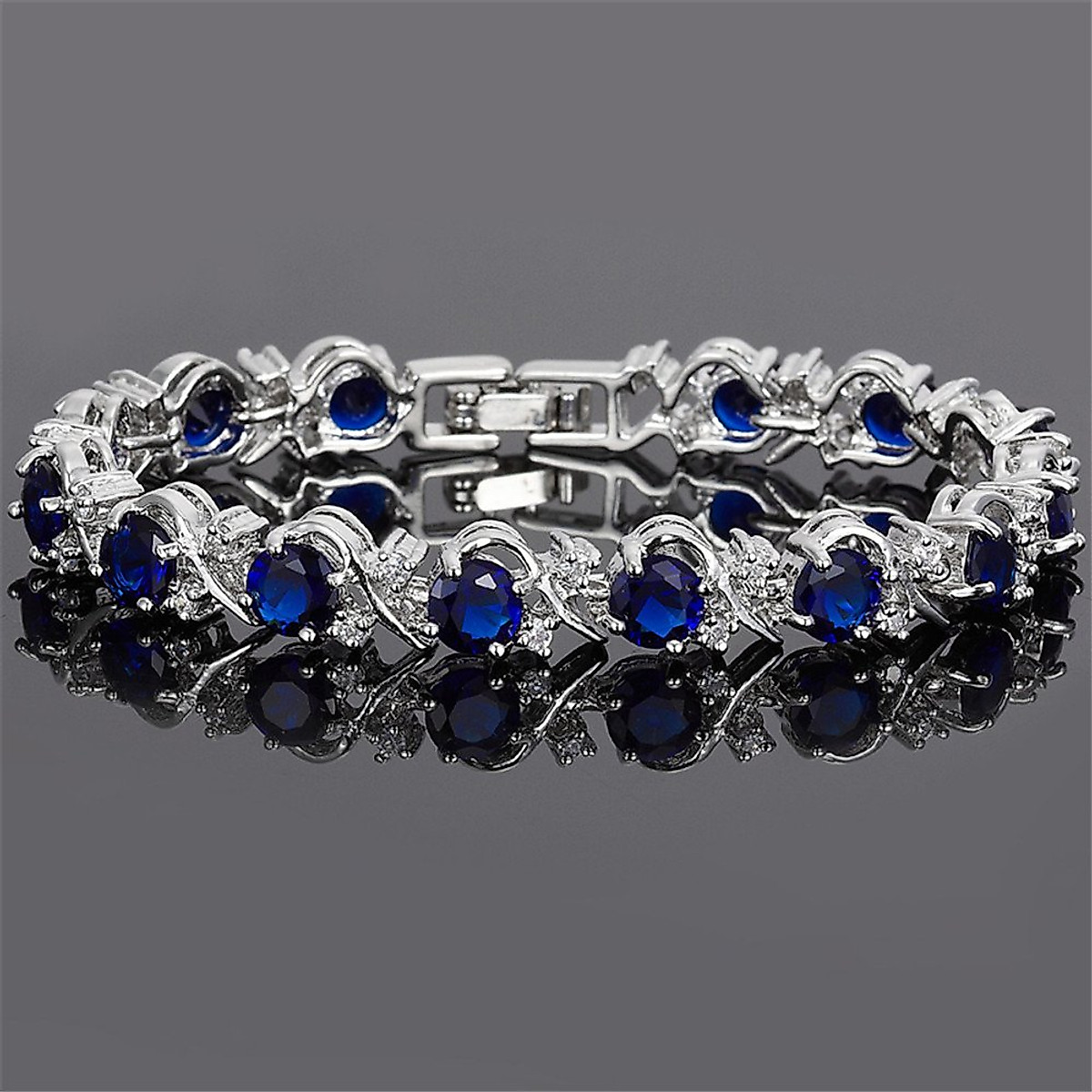RIZILIA Blossom Round Simulated Blue Sapphire and White Cubic Zirconia 18K White Gold Plated Tennis Bracelet, 7"