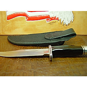 Custom Right-hand Leather knife sheath for the Buck 119 dyed black. Made with Authentic Buffalo Hide Leather and has round basket-weave tooling with strap. Sheath ONLY!!!!