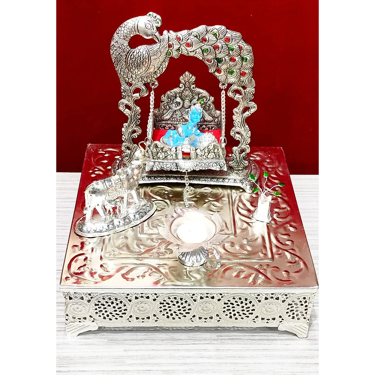Crafting with Love a Beautiful Little Krishna Peacock jhula with German Silver chowki + Cow Calf + tulsi Plant + Lotus Handle Diya