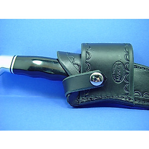 Buck 119 Cross Draw Knife Sheath. This Sheath Is Made Out of 8 Ounce Leather the Leather Is Very Soft Durable and Pliable You Will Not Need to Line Your Sheath for Your Finer Knives. The Leather Is Dyed Black with Border Tooling. The Sheath Can Be Worn on