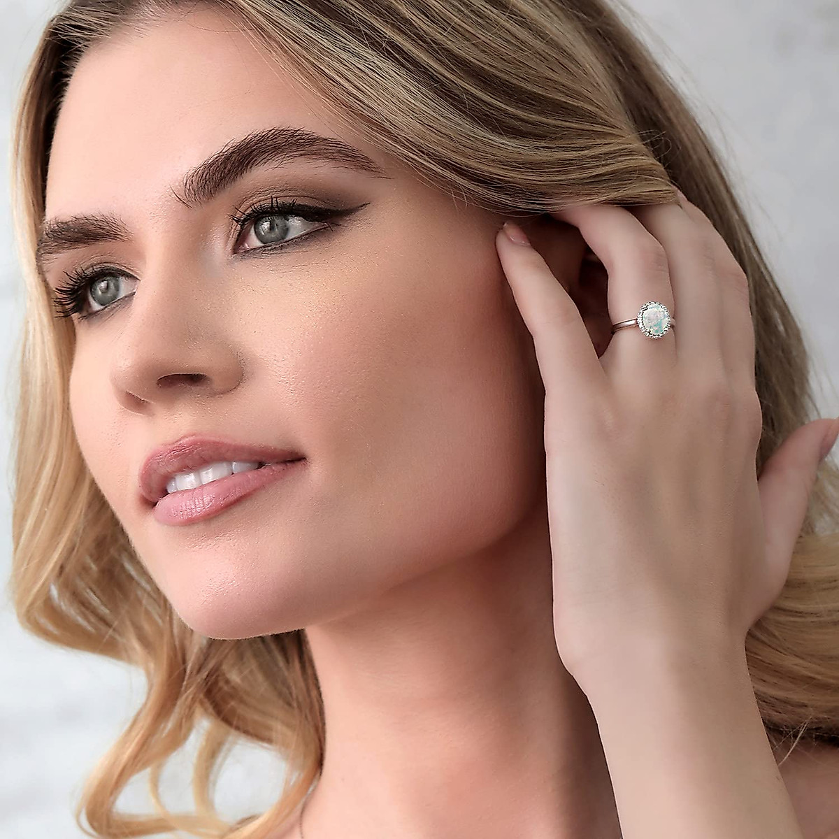 Gem Stone King 10K White Gold White Simulated Opal and Diamond Engagement Ring For Women (0.60 Cttw, Oval Cabochon 9X7MM) (Size 7)