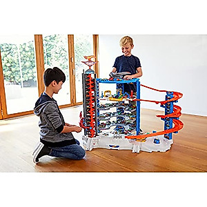 Hot Wheels Toy Car Track Set & 4 1:64 Scale Cars, Super Ultimate Garage, 3+ Ft Tall with Motorized Gorilla & Storage for 140 Cars