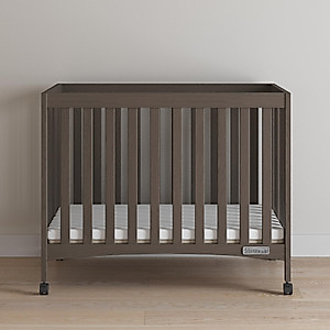 Child Craft London Mini Compact Folding Portable Crib with 2” Crib Mattress and 2 Easy Roll Locking Wheels, Durable Pine Wood Construction (Dapper Gray)