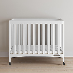 Child Craft London Mini Compact Folding Portable Crib with 2” Crib Mattress and 2 Easy Roll Locking Wheels, Durable Pine Wood Construction (Matte White)