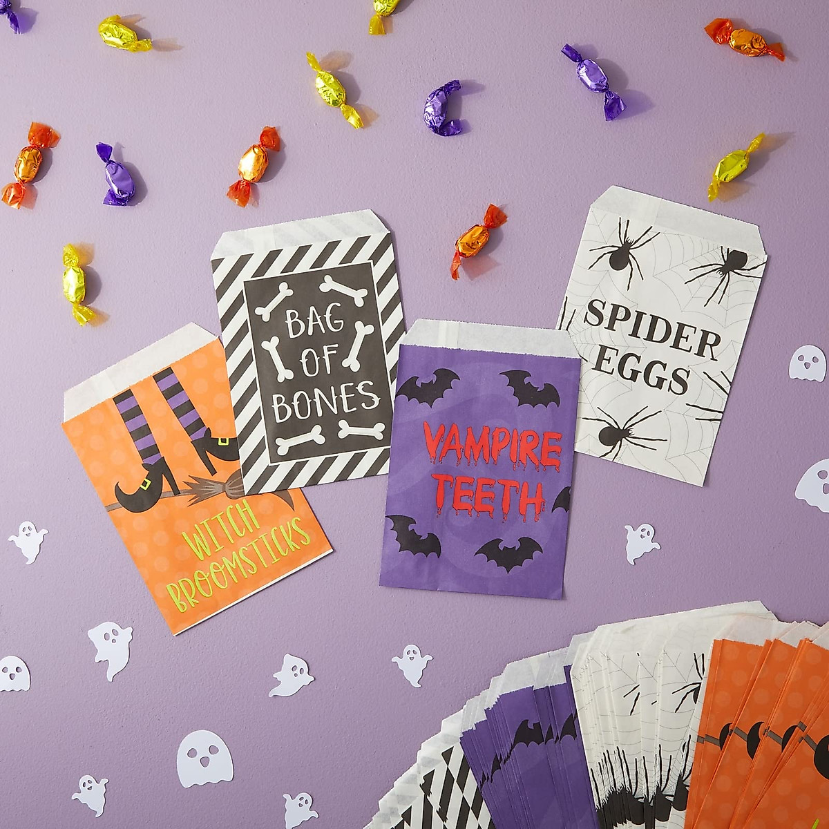 BLUE PANDA 100 Pack Halloween Paper Bags, Small Paper Halloween Treat Bags, Bulk Goody Bags for Candy, and Favors, 4 Designs, Vampire Teeth, Witch Broomsticks, Bag of Bones, Spider Eggs (8 x 5 In)