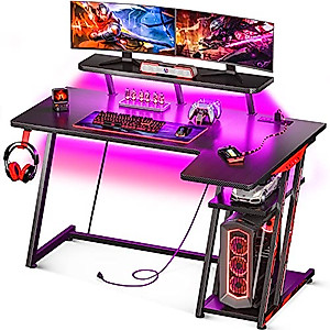 MOTPK L Shaped Gaming Desk with LED Lights, Corner Gaming Computer Desk 47inch with Power Outlets, Gaming Table with PC Storage Shelf, Gamer Desk with Monitor Shelf, Carbon Fiber Texture, Black