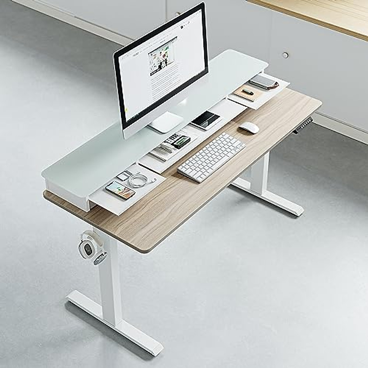 FEZIBO Electric Standing Desk with Double Drawers, 55 x 24 Inch Glass Top Monitor Stand Adjustable Sit Stand Desk with Storage Shelf, White Frame/LightWalnut Top