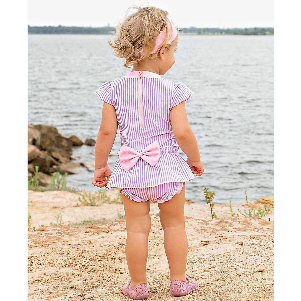 RuffleButts Infant/Toddler Girls Peplum Skirt One Piece Rash Guard Swimsuit - Lilac Seersucker - 12-18m
