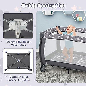 HONEY JOY Pack and Play with Bassinet, 4-in-1 Portable Baby Playard with Changing Table, Net & Cute Toys, Diaper Storage Bag, Music Box, Wheels with Brake, Foldable Newborn Play Yard w/Carry Bag