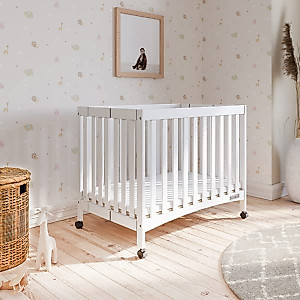 Child Craft London Mini Compact Folding Portable Crib with 2” Crib Mattress and 2 Easy Roll Locking Wheels, Durable Pine Wood Construction (Matte White)