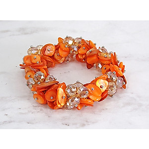 Calisa Designs Woman's orange shell and glass beaded stretch bracelet with silver beads, Designed with clusters of orange shell and orange facet cut glass beads.