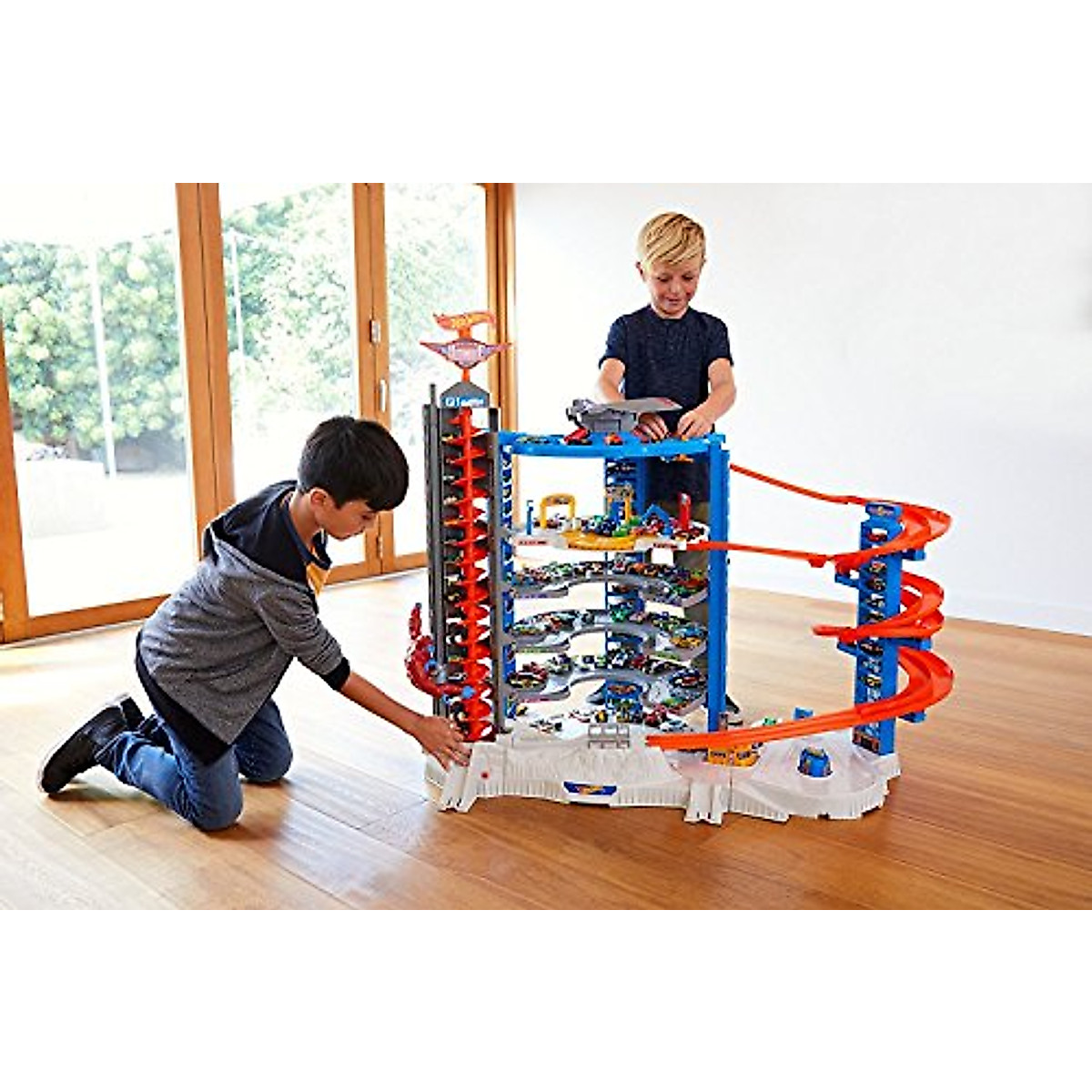 Hot Wheels Toy Car Track Set & 4 1:64 Scale Cars, Super Ultimate Garage, 3+ Ft Tall with Motorized Gorilla & Storage for 140 Cars