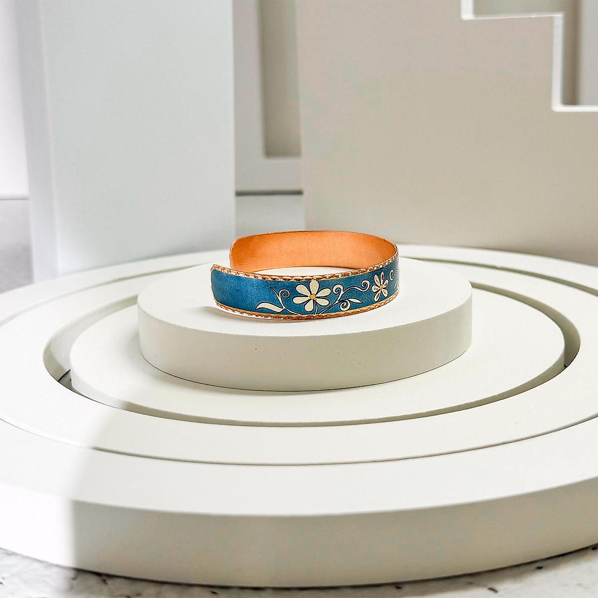 Women's Daisy Flower Bracelets feature a beautiful daisy flower on a blue copper cuff with an open-ended flower cuff design. These copper bracelets are adjustable for a perfect fit—BNF-06.