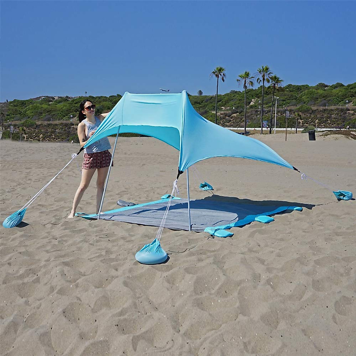 Titan Beach Canopy Sky Blue Sunshade with Sandbag Anchors and Mat - 7ft x 7ft - UPF 50+ - Tent Includes Carry Bag - Weighs 5 Pounds - Portable, Family Sun Protection for The Beach, Park or Camping