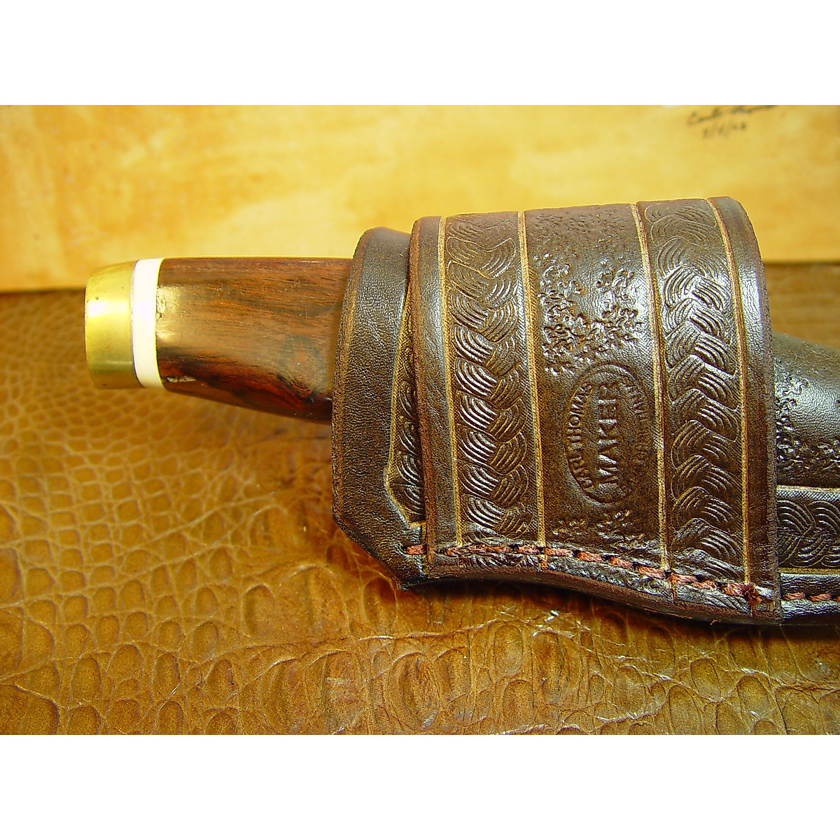 New Buck Vanguard Cross Draw Knife Sheath. Made of 10 Oz Water Buffalo Leather and Has a Rope Pattern Tooling with Random Patterning in the Center of the Sheath. Sheath ONLY!
