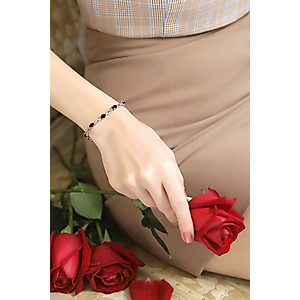 B. BRILLIANT Sterling Silver Synthetic Ruby and White Topaz Oval-Cut Swirl Tennis Bracelet