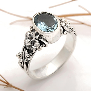 NOVICA Artisan Handmade Blue Topaz Single Stone Ring Oval Cut Silver with Floral Design Sterling Cocktail Indonesia Serenity Birthstone [crownbezel 0.4 in L x 0.3 in W x 0.3 in H Band Width 4 mm W]