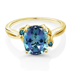 Gem Stone King 18K Yellow Gold Plated Silver Millennium Blue Mystic Topaz and Blue Diamond 3 Stone Ring For Women (3.03 Cttw, Oval 10X8MM, Gemstone Birthstone, Available In Size 5, 6, 7, 8, 9)