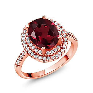 Gem Stone King 18K Rose Gold Plated Silver Red Rhodolite Garnet and Moissanite Halo Engagement Ring For Women (2.43 Cttw, Oval 9X7MM, Gemstone Birthstone, Available In Size 5, 6, 7, 8, 9)
