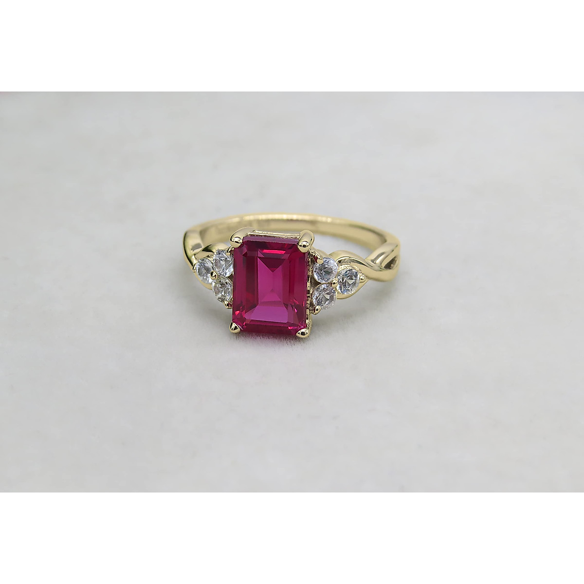 Dazzlingrock Collection 8x6mm Emerald Shape Center Lab Created Ruby & 2.2mm Round White Sapphire on Side Crisscross Shank Engagement Ring for Her in 10K Yellow Gold Size 7